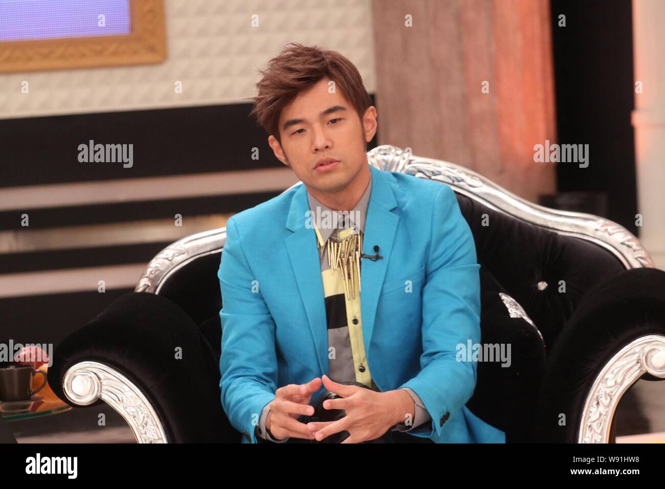 Taiwanese singer and actor Jay Chou reacts during a record of TV show ...