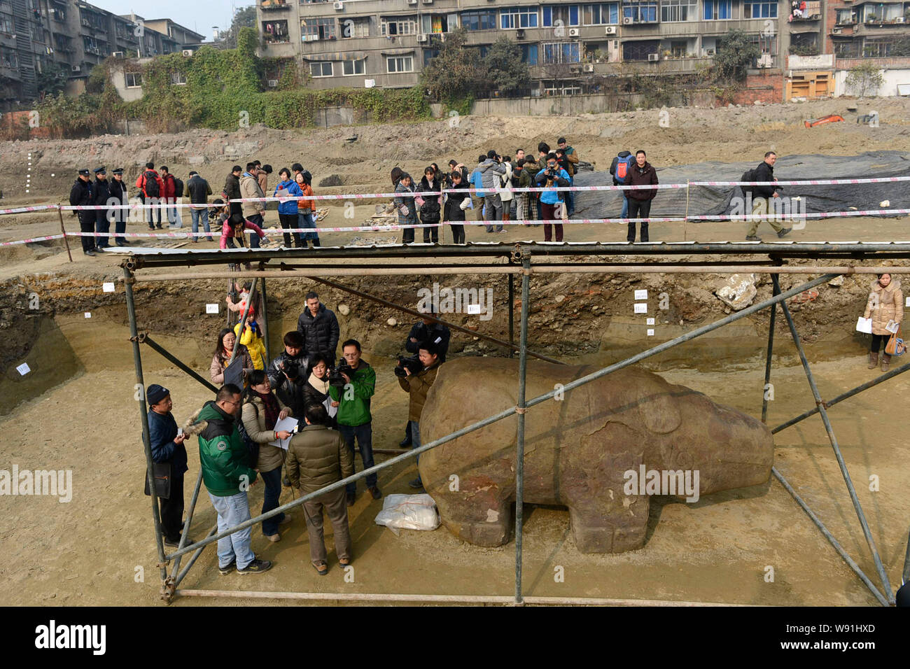 An archaeologist is interviewed by journalists next to a 2,000-year-old ...