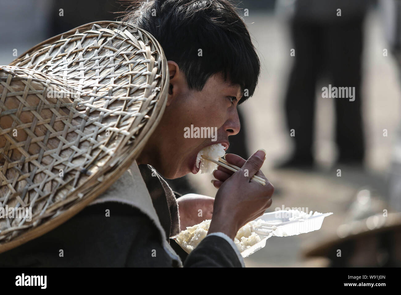 --FILE--A Chinese extra eats at lunchtime during a filming session of a TV series at Hengdian ...