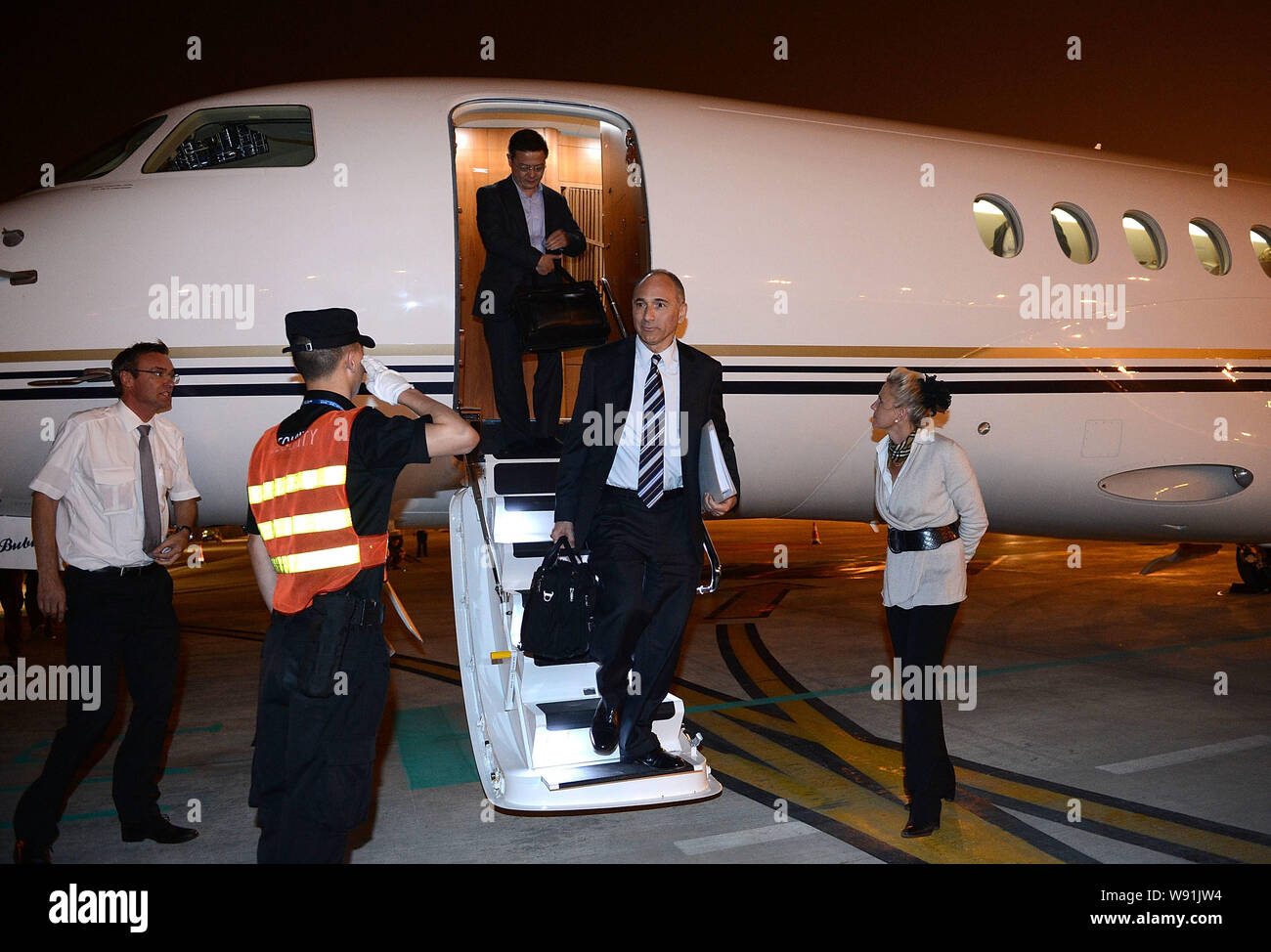 Novartis CEO Joseph Jimenez, second right, deplanes from a jet at the ...
