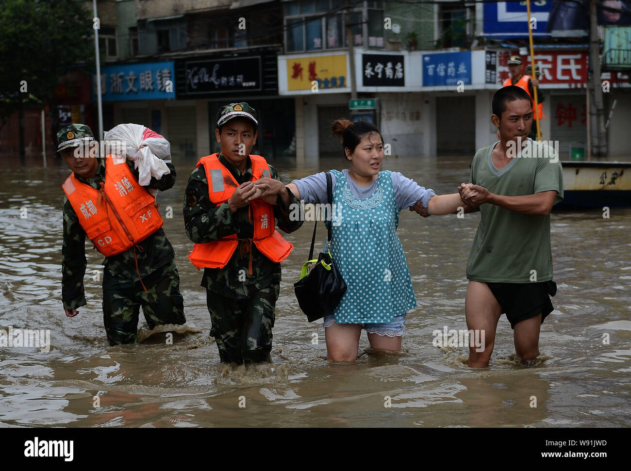 Chinese rescuers evacuate local residents from flooded areas caused by ...