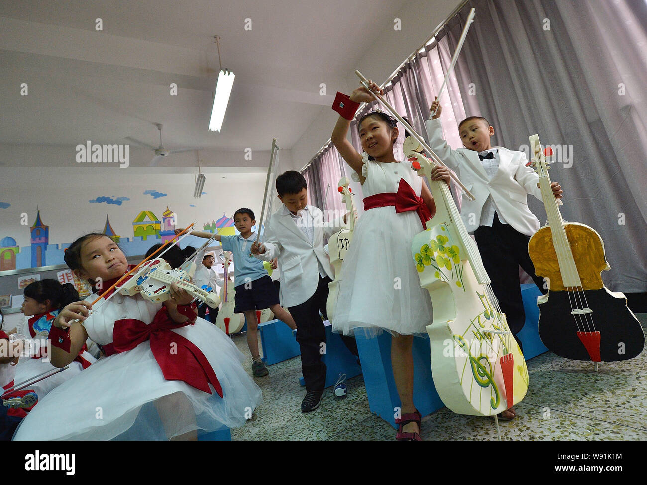 Young students of the Paper Orchestra play their paper-made musical ...