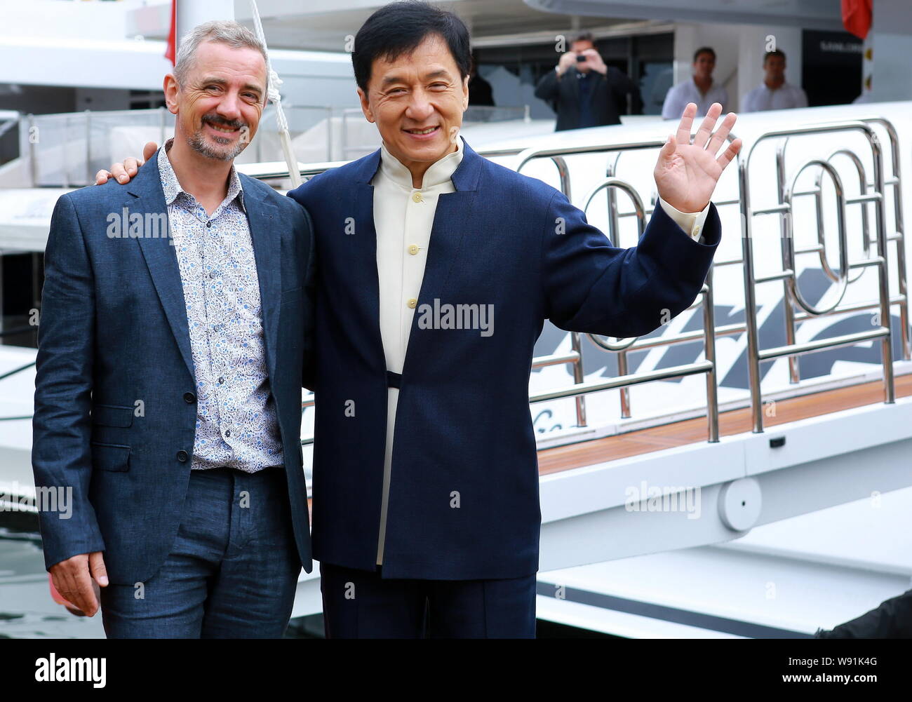 Hong Kong kungfu superstar Jackie Chan, right, waves as he poses with ...
