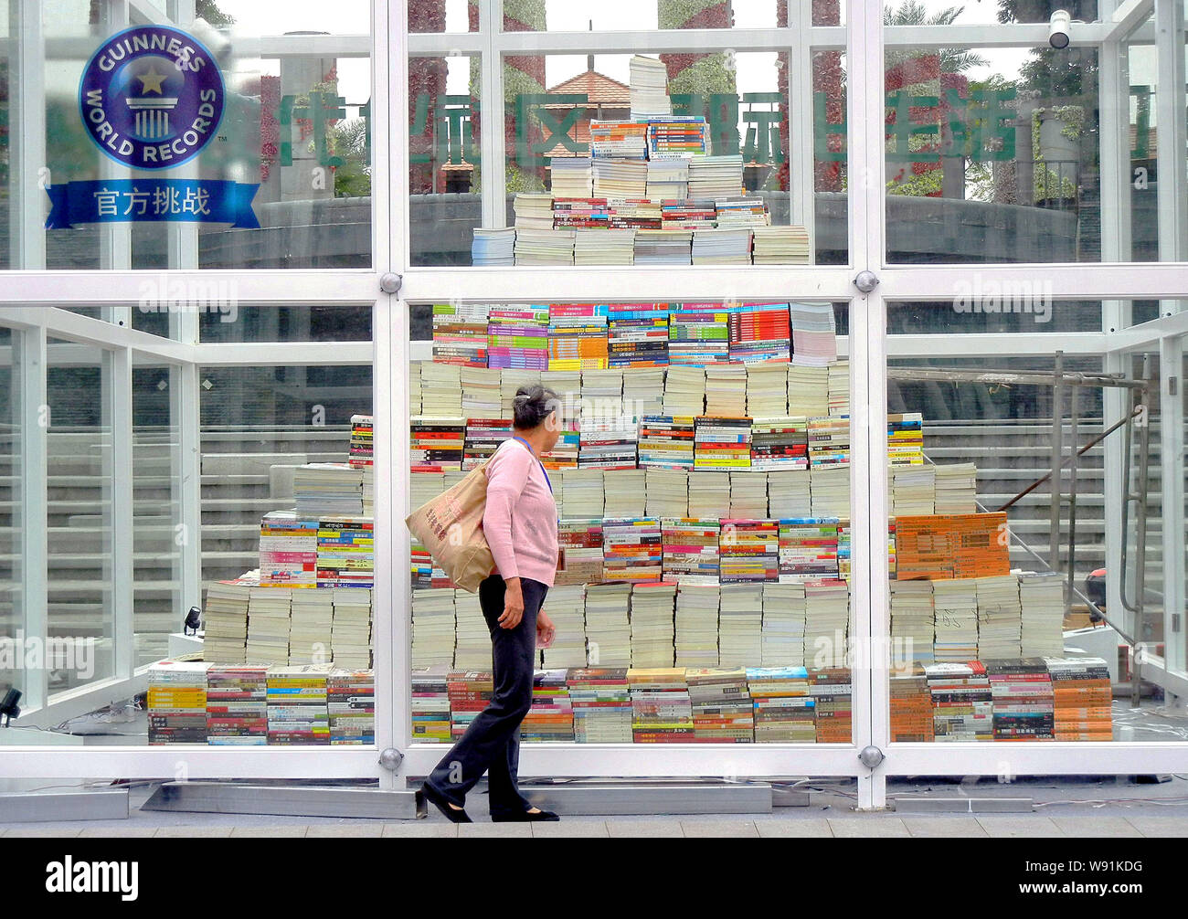 A pedestrian looks at the worlds biggest book tower made up of 19,236 ...