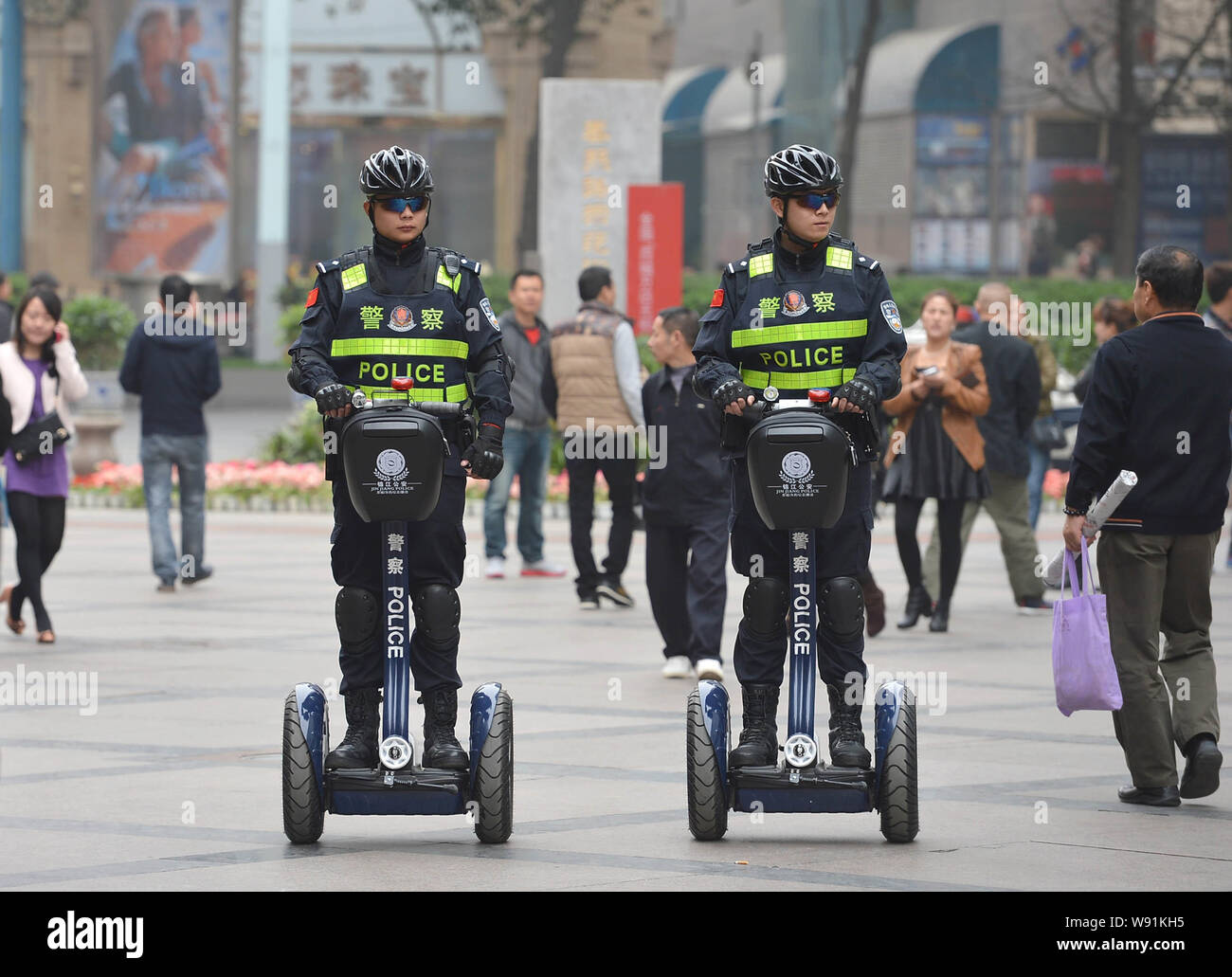 Chinese police officers ride Segway-like two-wheeled electric vehicles ...