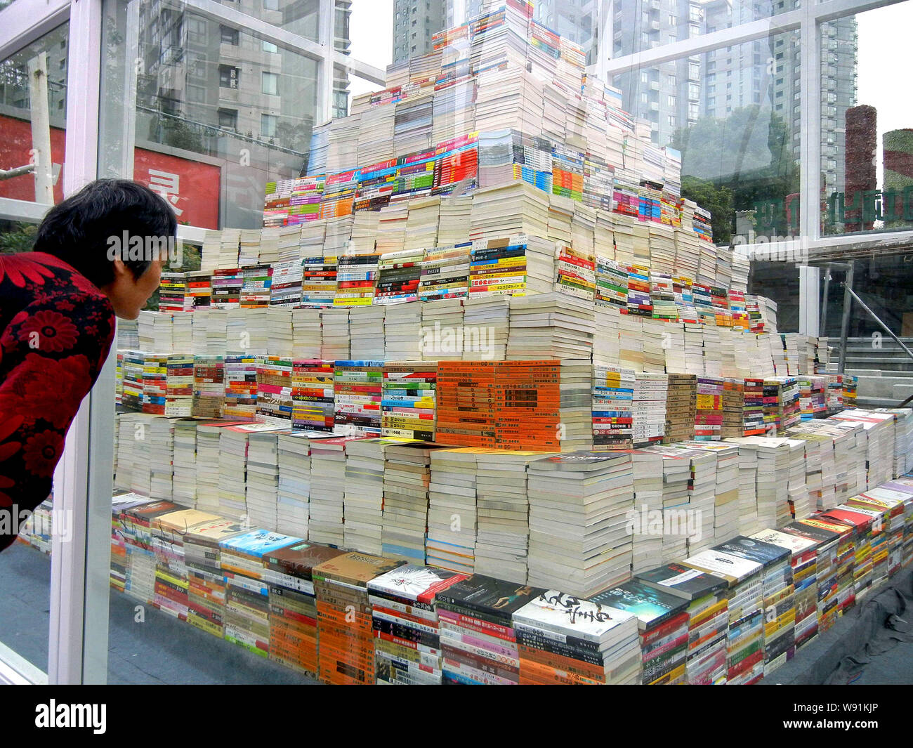 A pedestrian looks at the worlds biggest book tower made up of 19,236 ...