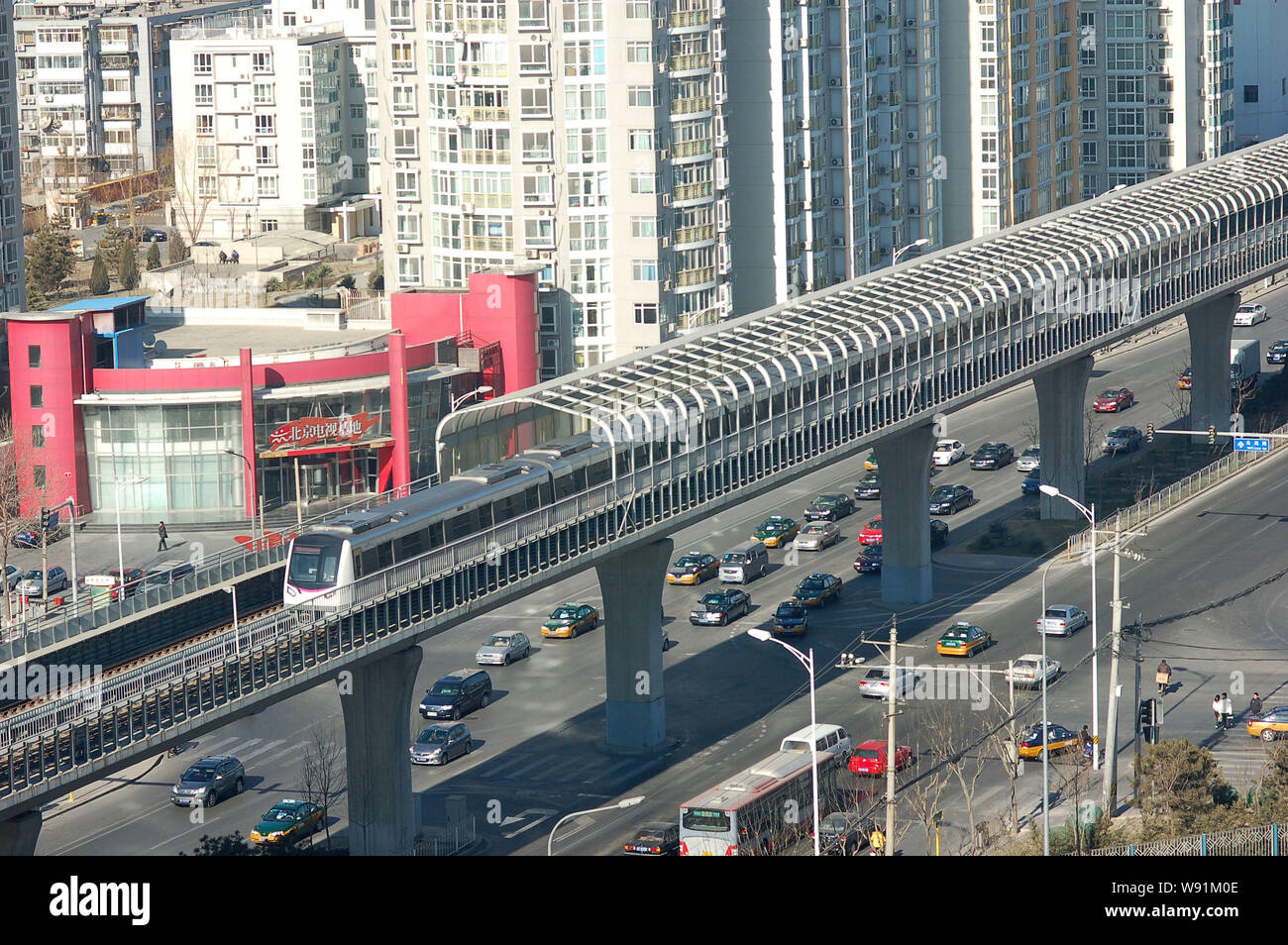 --FILE--A metro train runs on an elevated track in Beijing, China, 13 ...