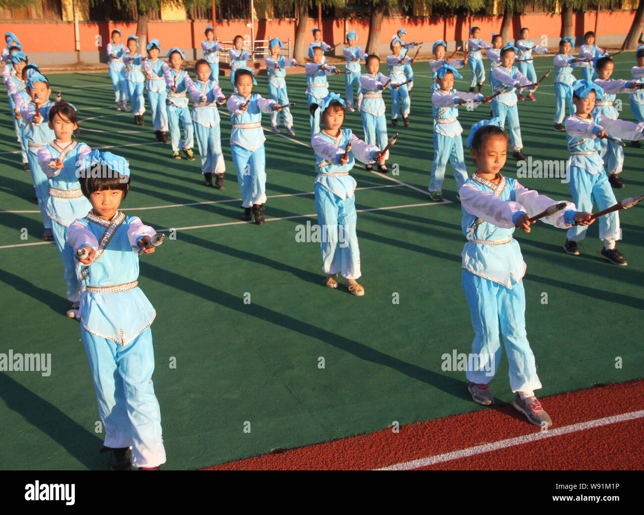 Young Chinese students practice calligraphy-themed physical exercises ...