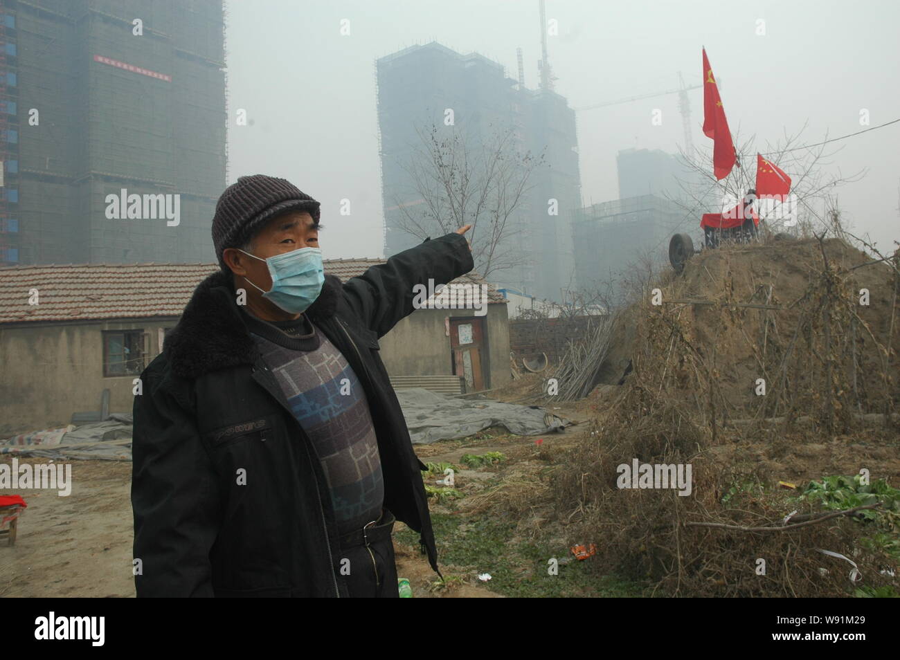 Chinese house owner surnamed Zhou points to his homemade cannon to be ...
