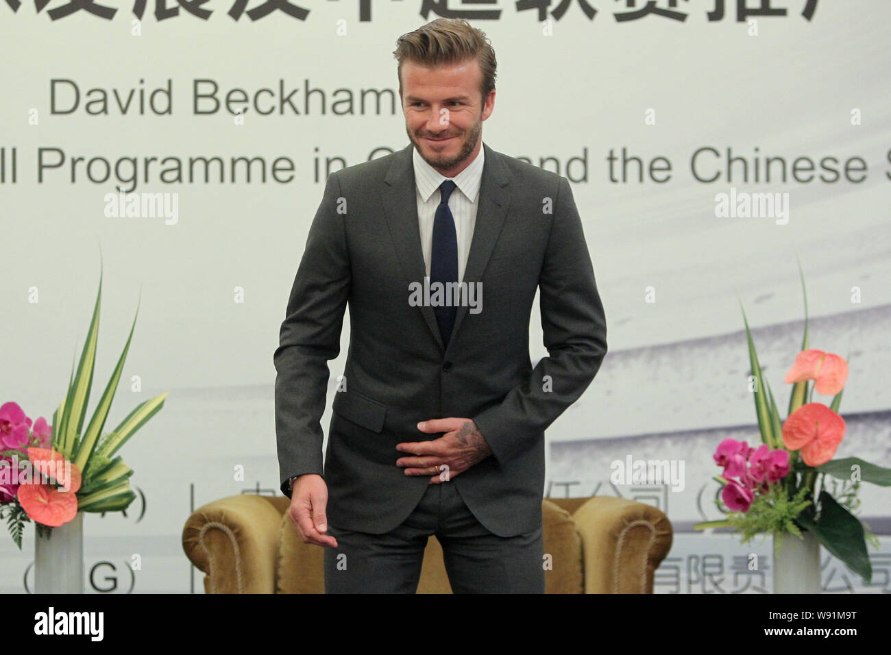 English football superstar David Beckham smiles as he is seated at a ...