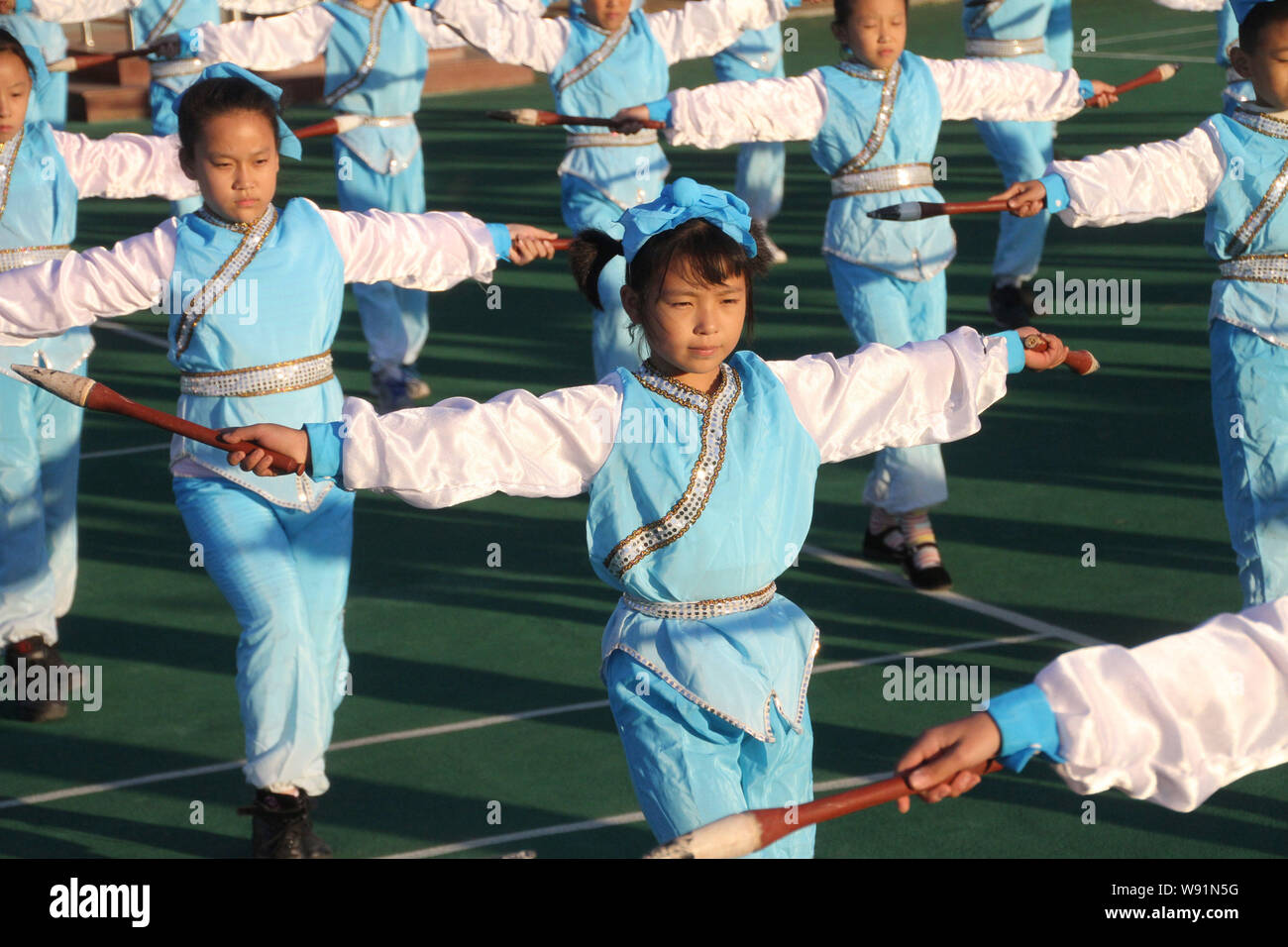 Young Chinese students practice calligraphy-themed physical exercises ...