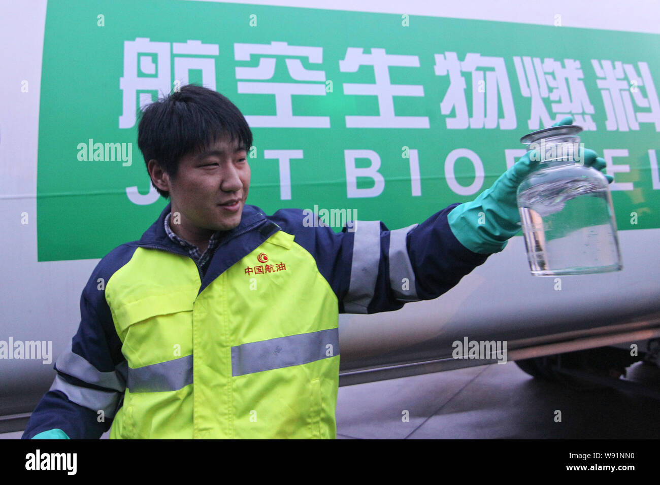 A Chinese ground crew member shows a bottle of biofuel during a test ...