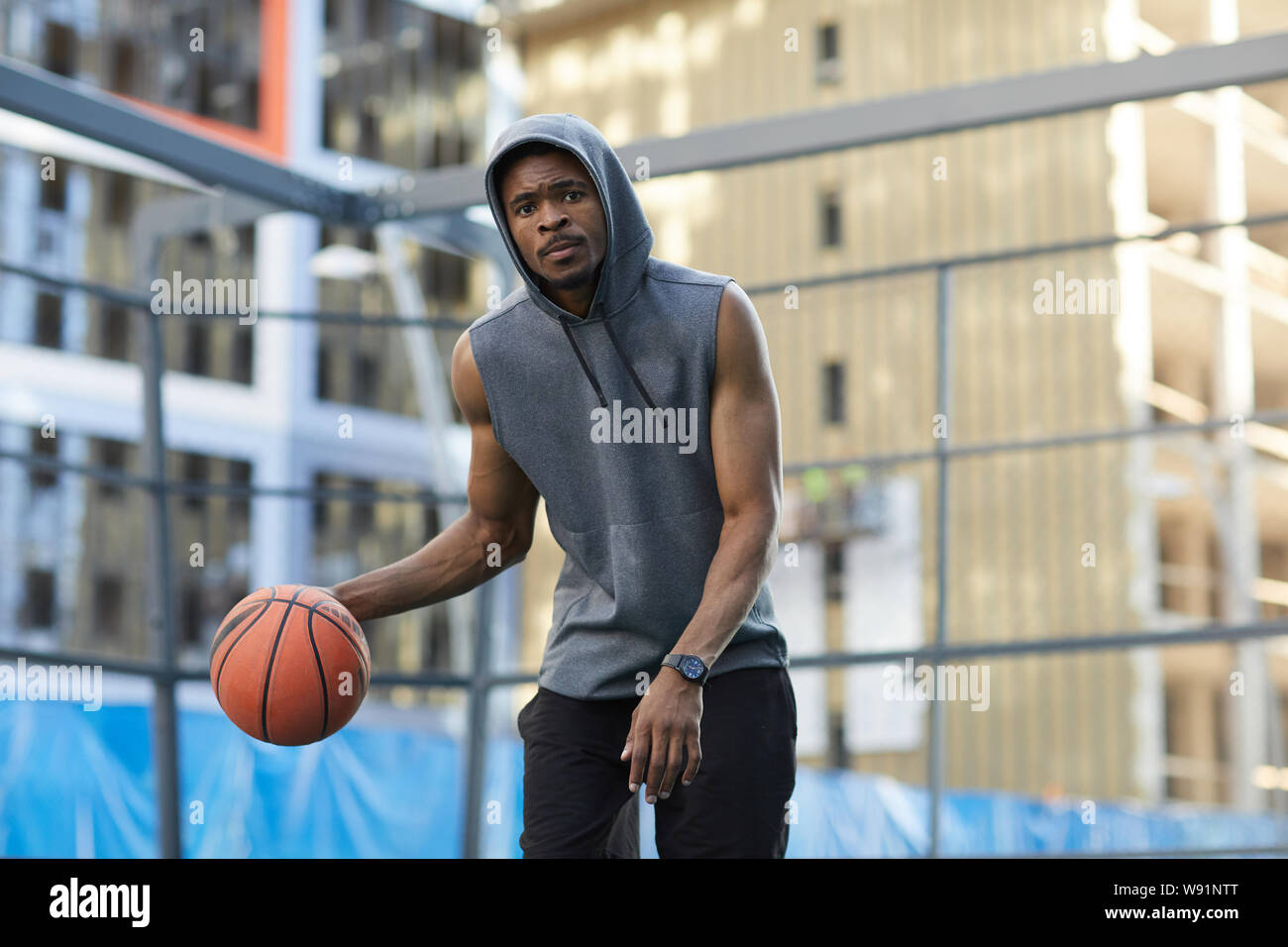Action portrait of African basketball player practicing in outdoor ...
