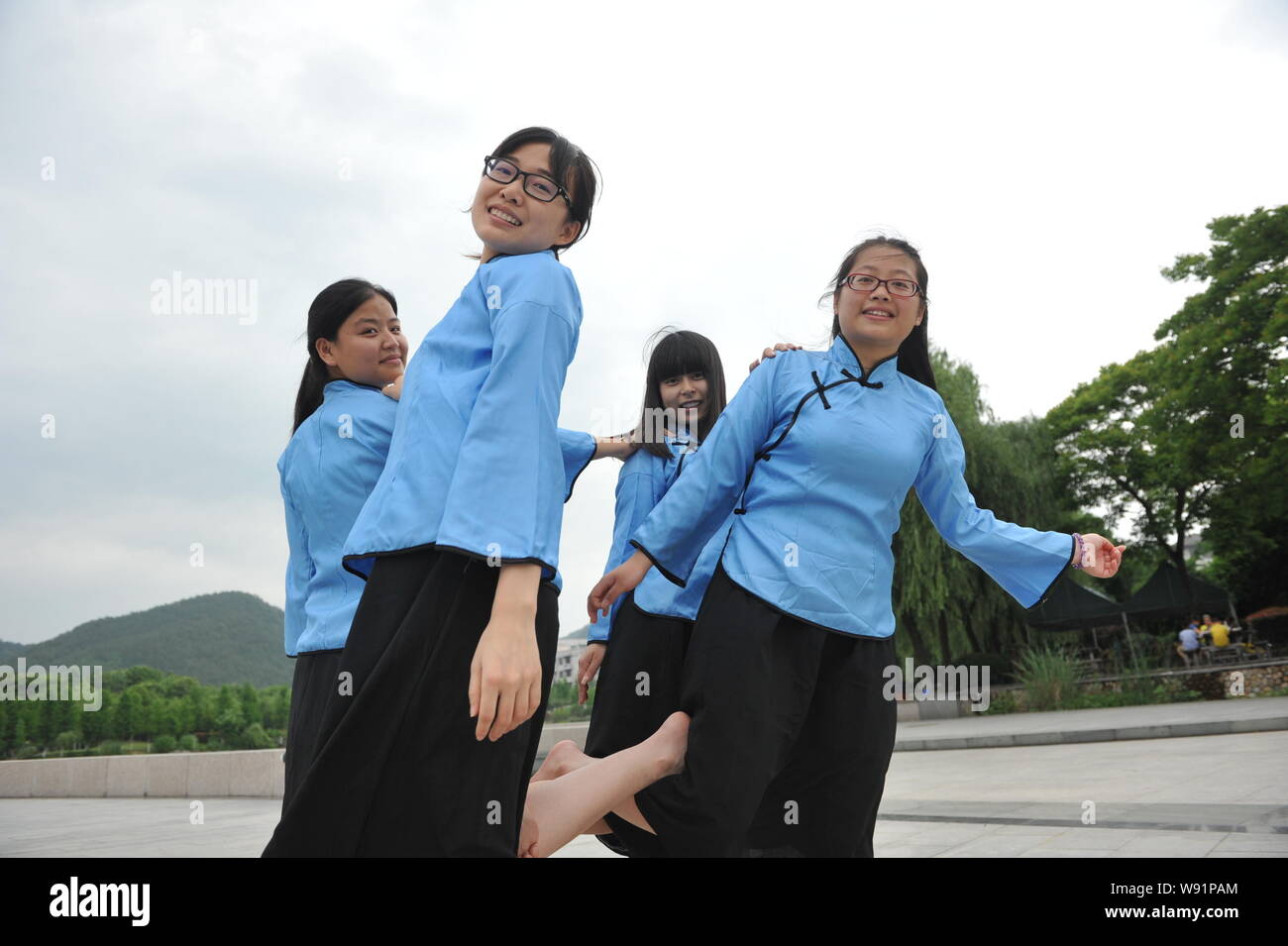 --FILE--College graduates wearing period costumes pose for graduation ...