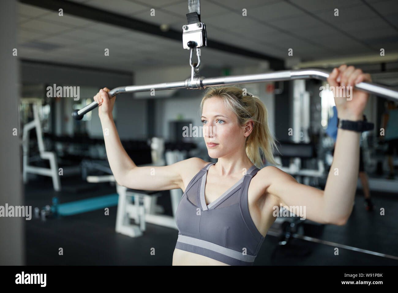 Young woman at the train station straightening her chest as strength ...