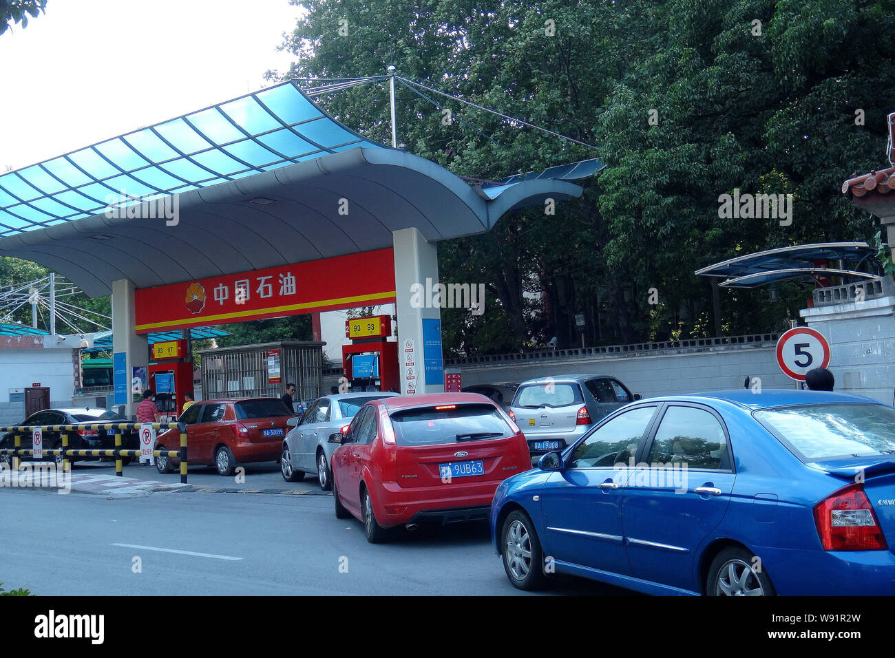 --FILE--Cars to be refueled line up at a gas station of CNPC (China ...