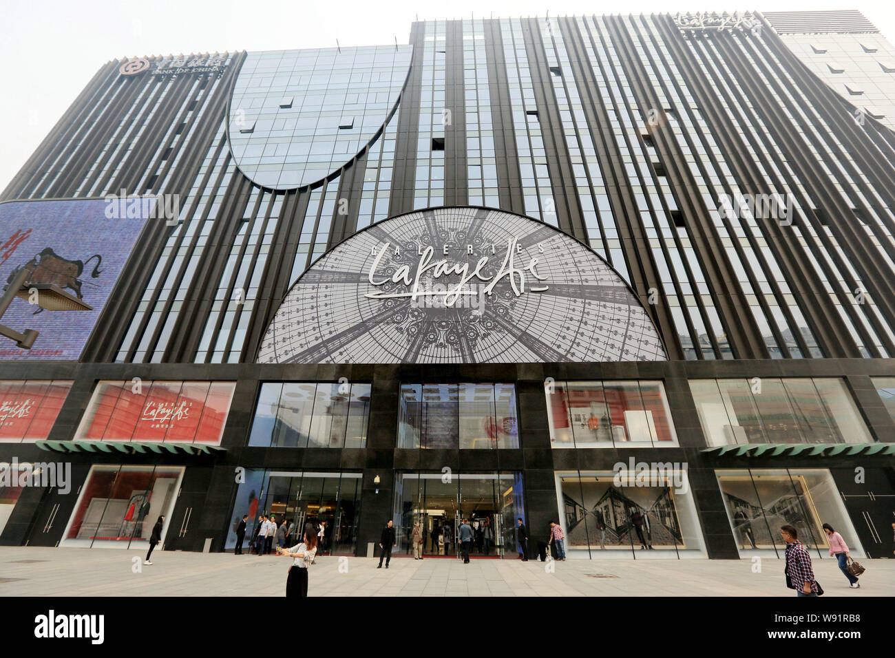 --FILE--Pedestrians walk past the newly-opened Galeries Lafayette ...
