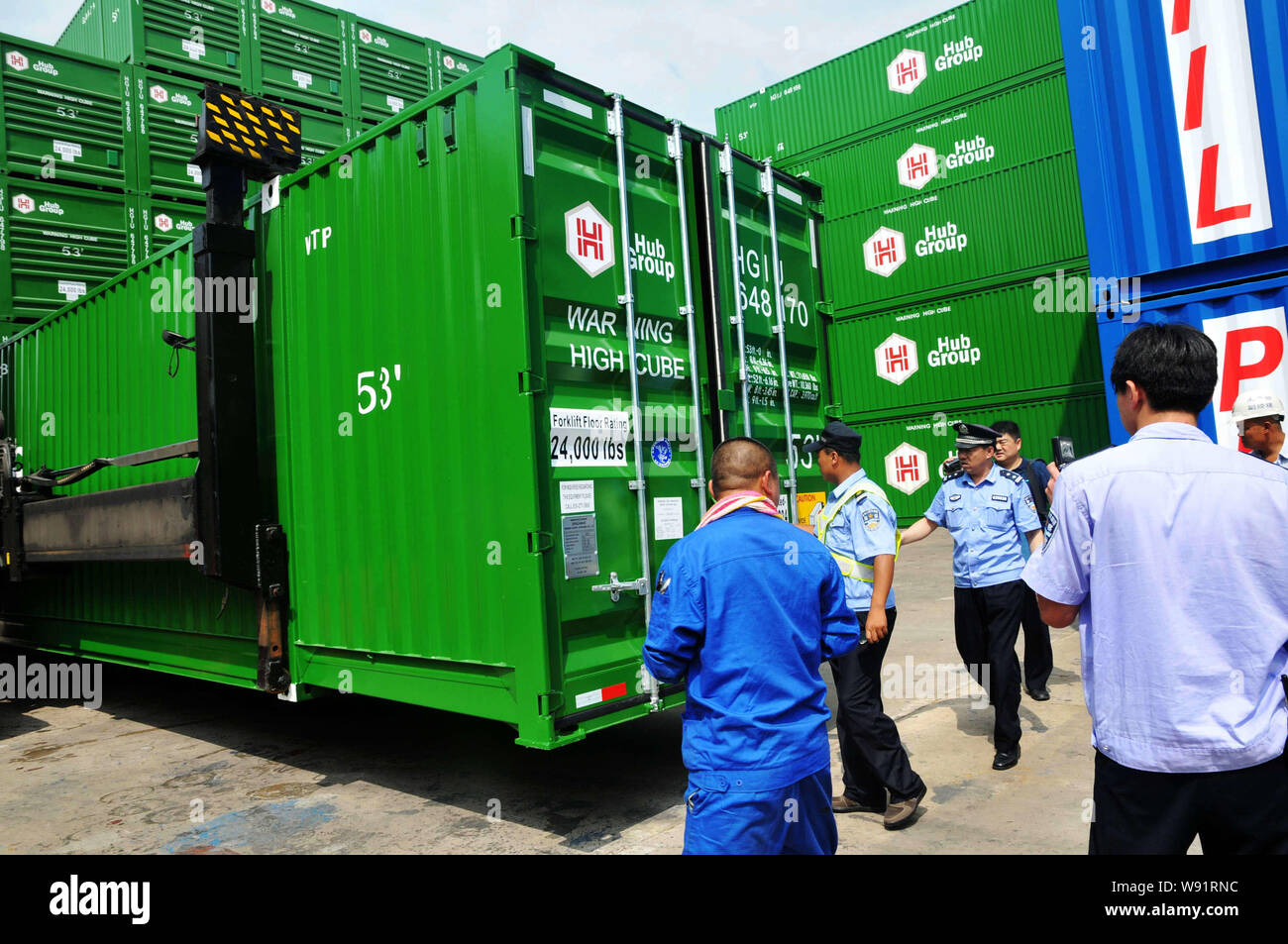 Police officers open the door of the container in which Mr. Jiang had ...