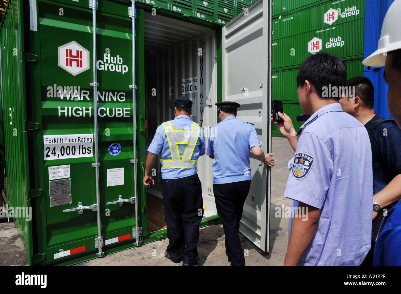 Police officers open the door of the container in which Mr. Jiang had ...