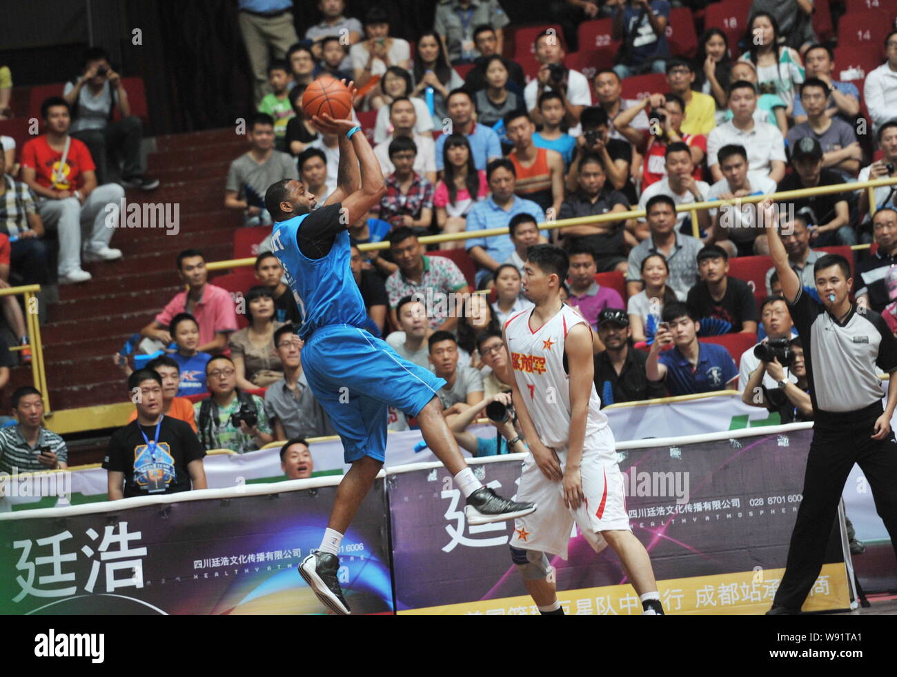 Tracy McGrady of the U.S. Legendary Superstars Team, left, jumps to ...