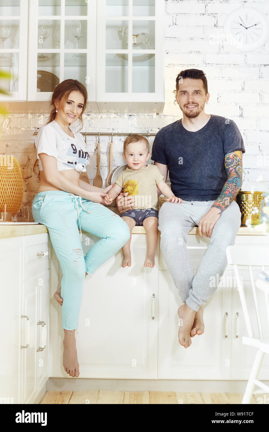 Married couple and their little baby baby in her arms. Young family at ...