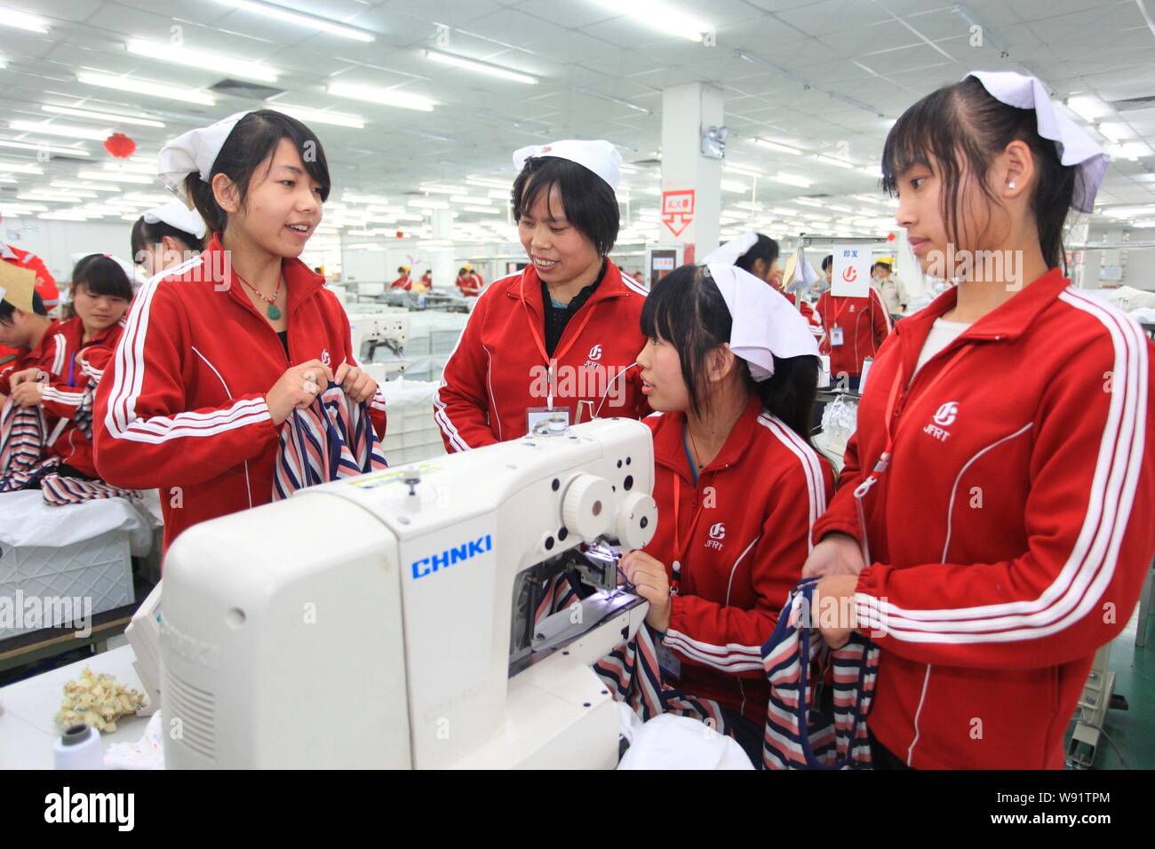 --FILE--Chinese workers talk at a garment factory of Jasfeel Group in ...