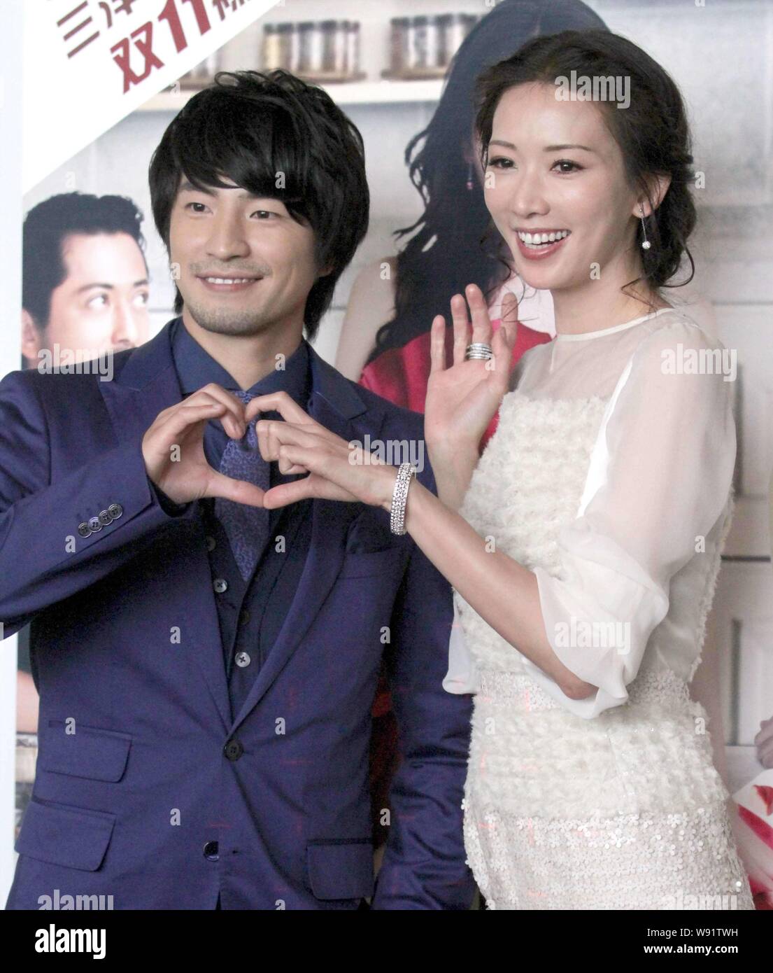 Taiwanese model and actress Lin Chi-ling, right, waves as she poses with Japanese actor Yusuke ...