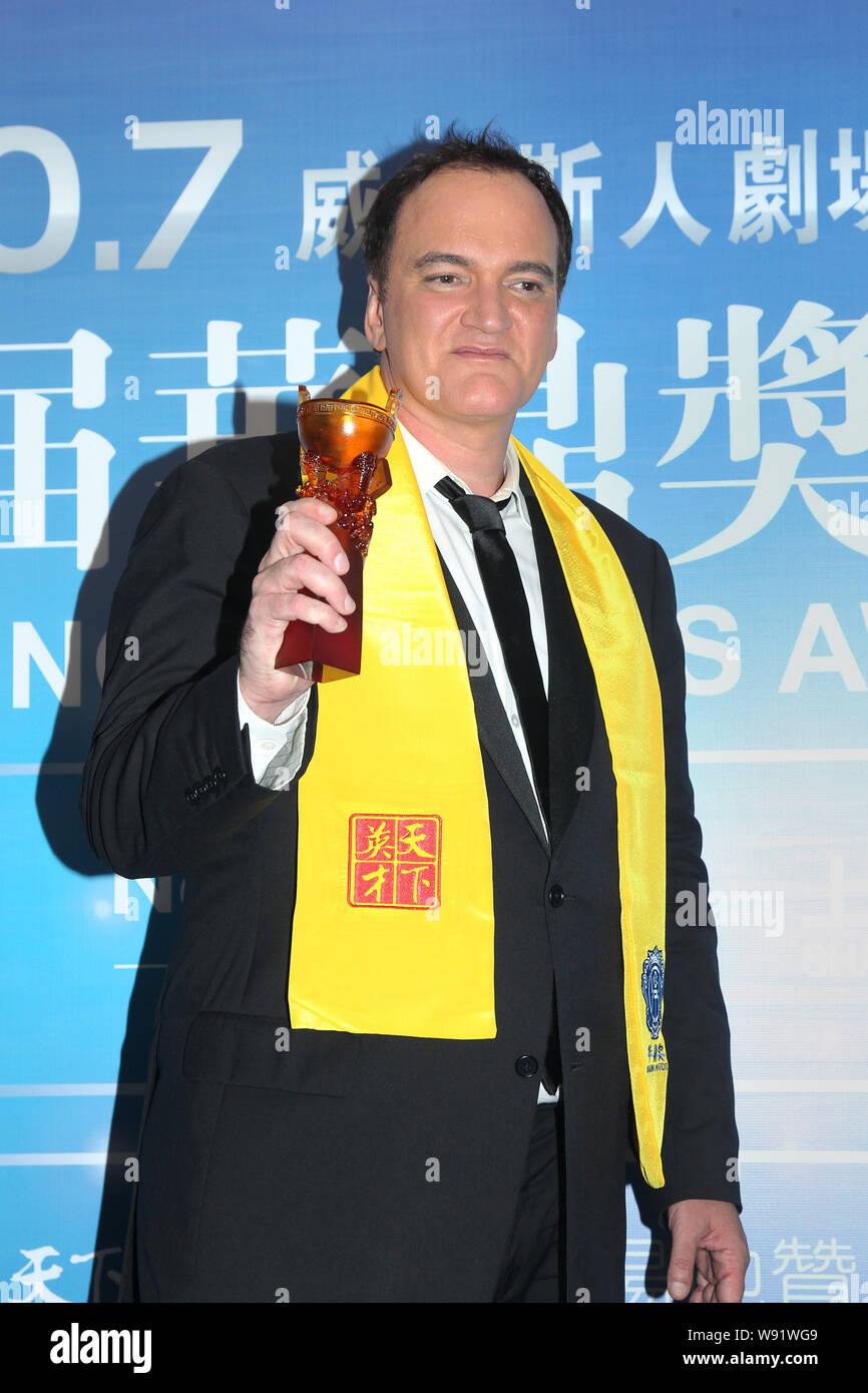 American film director Quentin Tarantino holds his trophy at the back ...