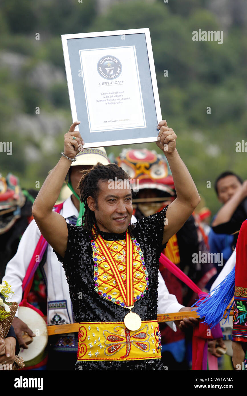 Chinese Uighur tightrope walker Aisikaier Wubulikaisimu holds up his ...