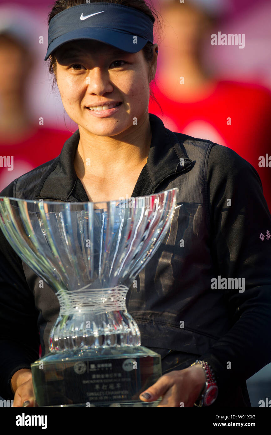 Chinese tennis player Li Na shows her trophy after she won the champion ...