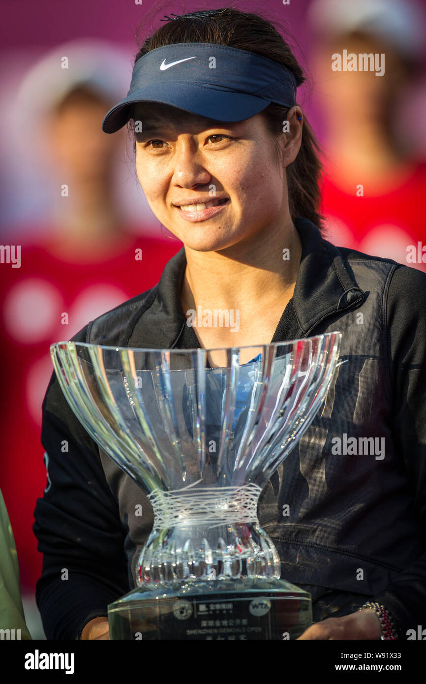 Chinese tennis player Li Na shows her trophy after she won the champion ...