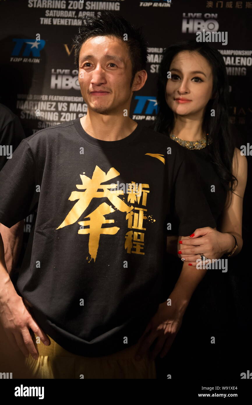Chinese Olympic boxing champion Zou Shiming (front) and his wife pose ...