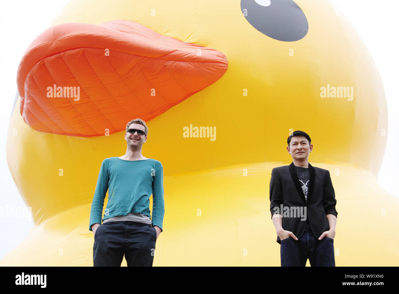Hong Kong singer and actor Andy Lau (right) poses in front of the giant ...