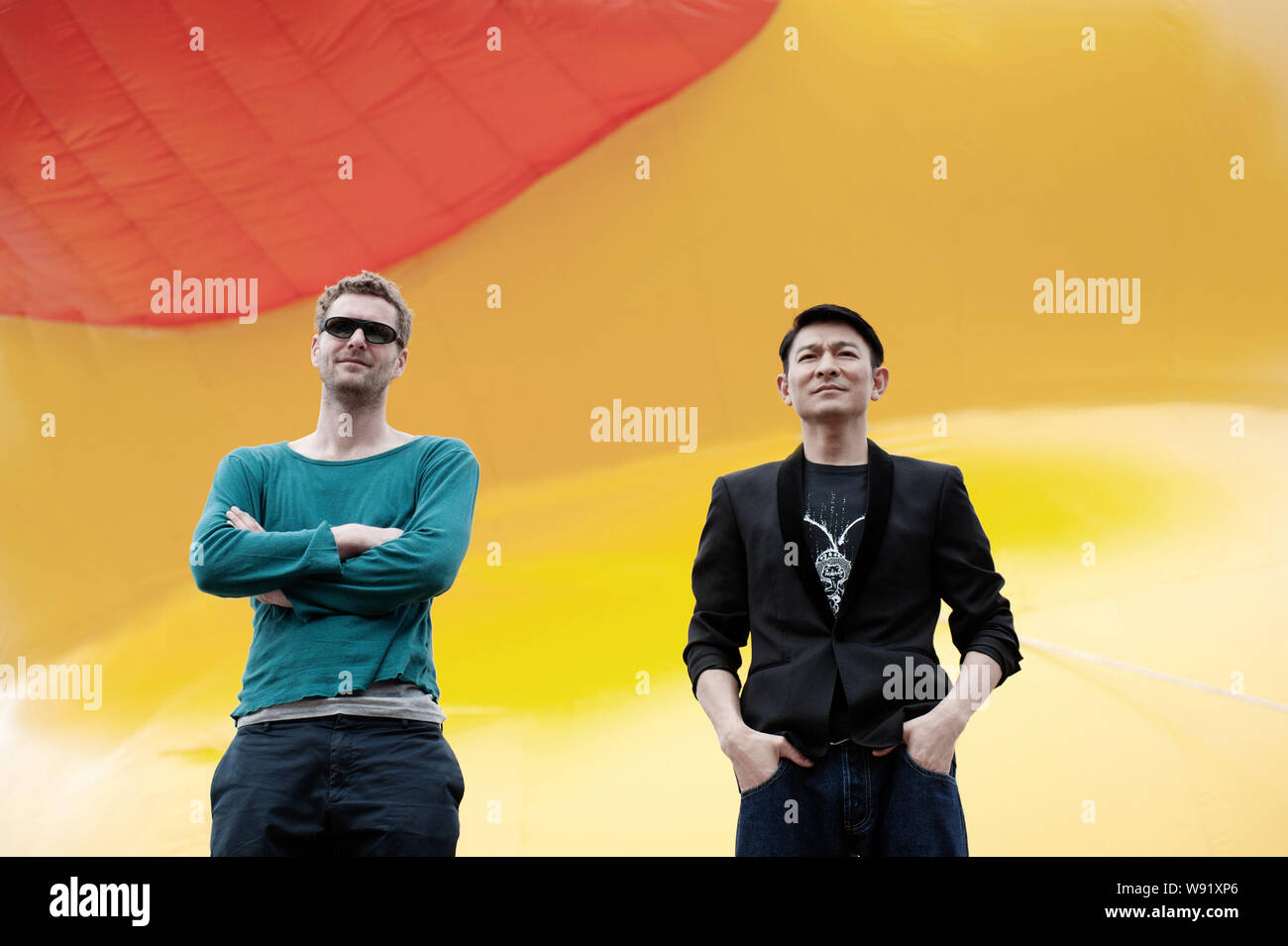 Hong Kong singer and actor Andy Lau (right) poses in front of the giant ...
