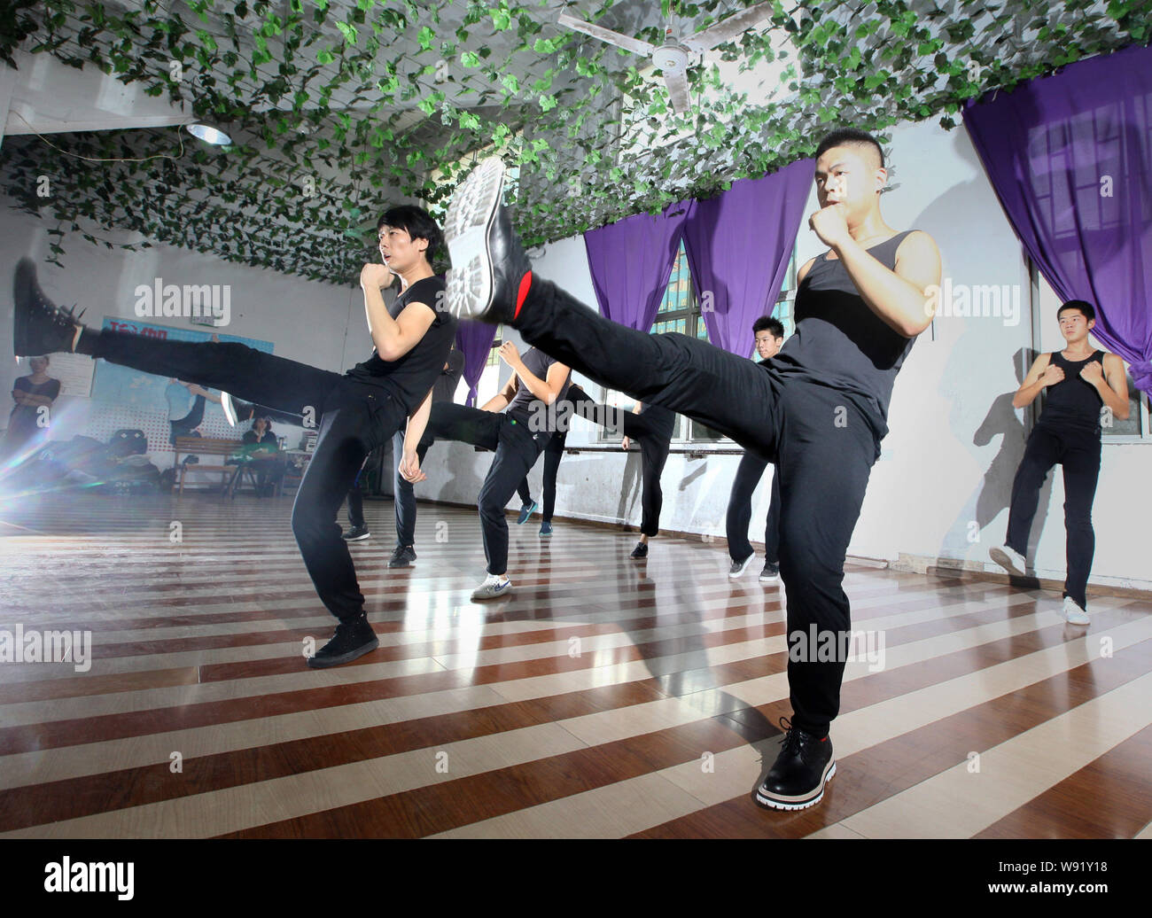 Male Chinese students practice fighting movements during a model ...
