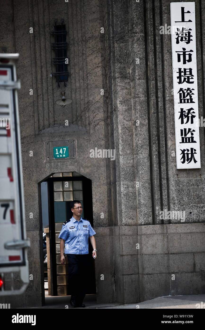 A Chinese police officer walks out from Tilanqiao Prison in downtown ...