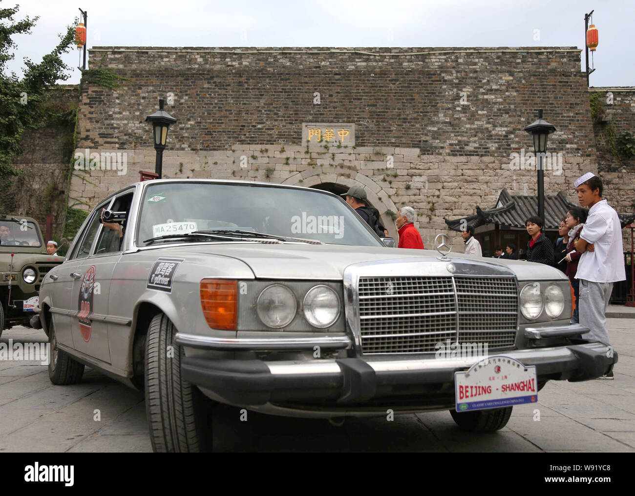 Visitors look at an old timer car of Mercedes-Benz during the Classic ...