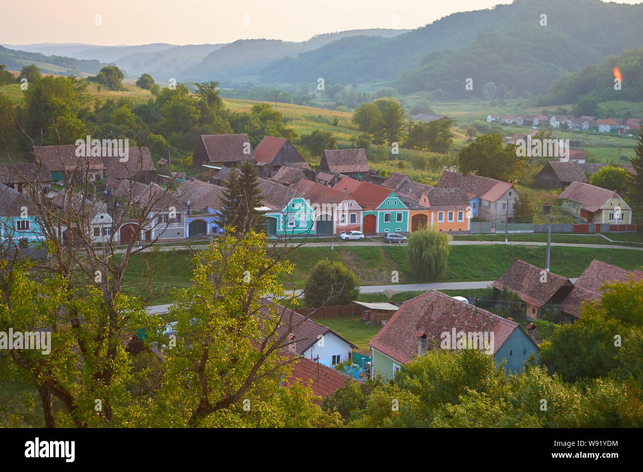 Alma Vii village in Transylvania, Romania, at sunset, with colorful ...