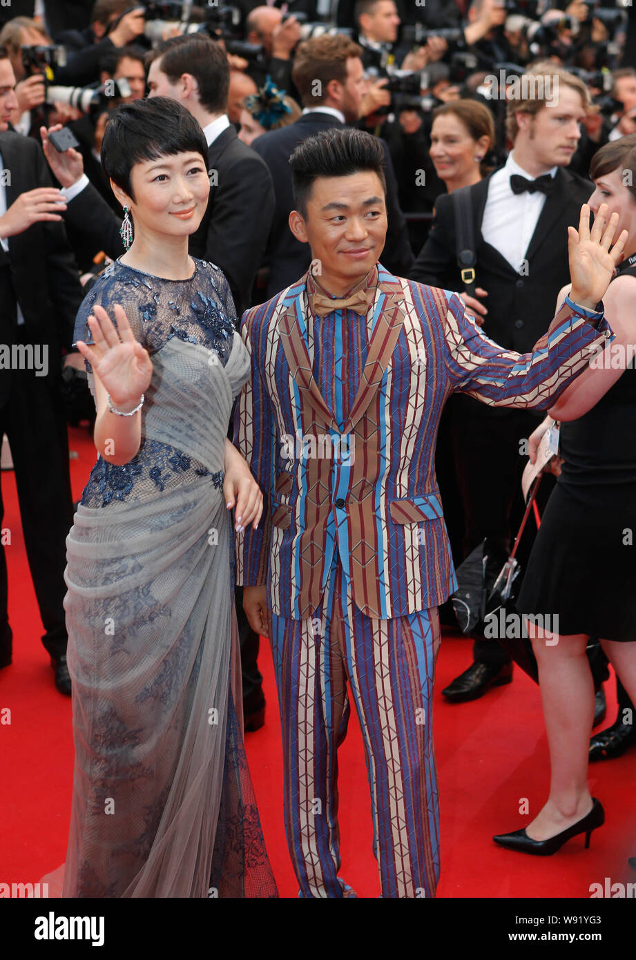 Chinese actress Zhao Tao, left, and actor Wang Baoqiang wave on the red ...
