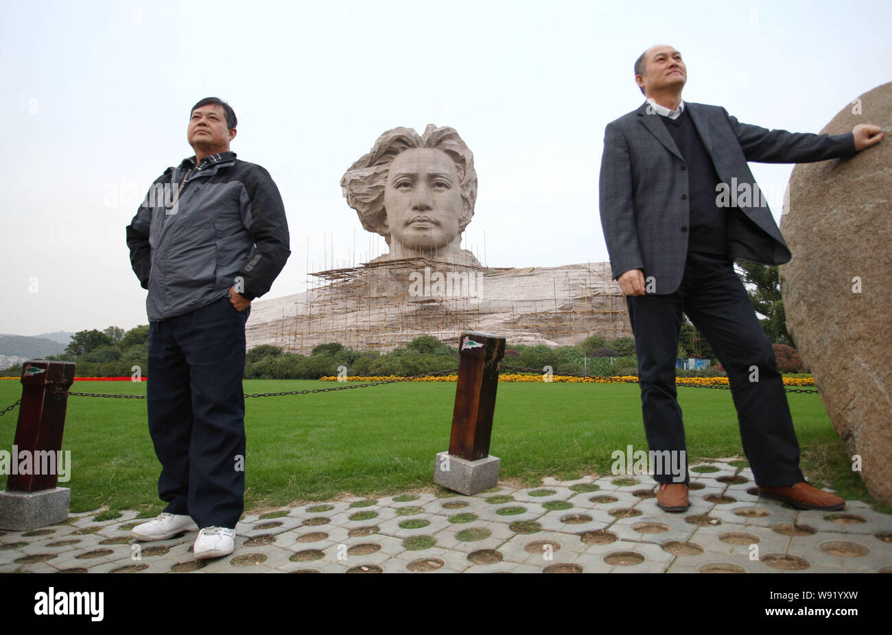 --FILE--Visitors pose for photos in front of the giant stone statue ...