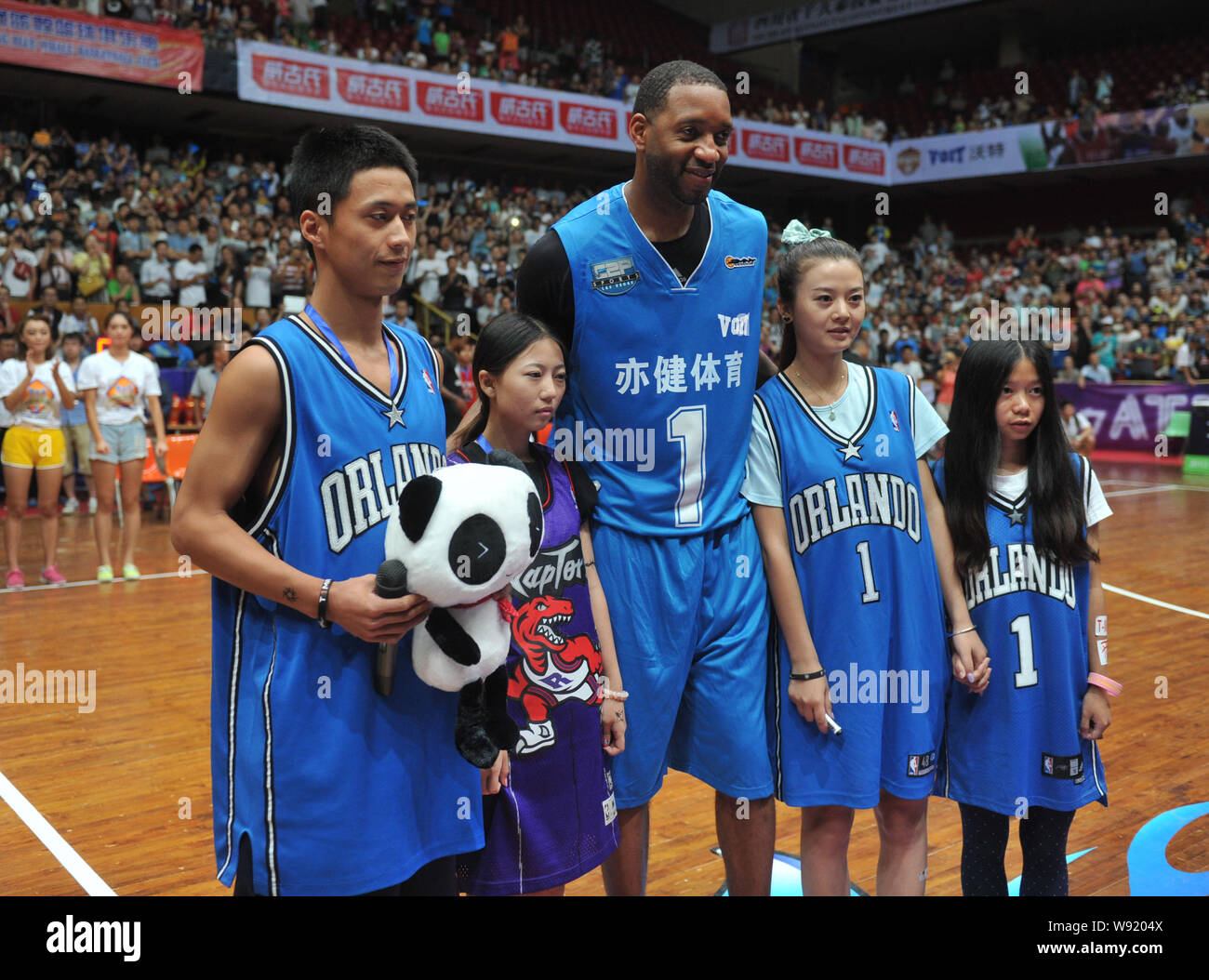 Tracy McGrady of the U.S. Legendary Superstars Team, center, poses with ...