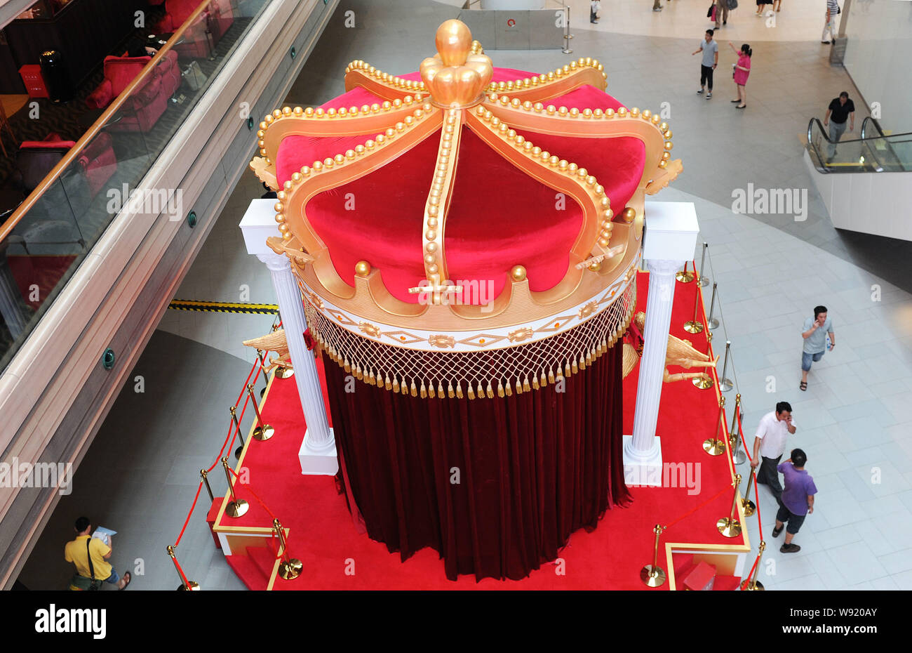 Customers walk past the giant crown at Henderson Metropolitan shopping ...