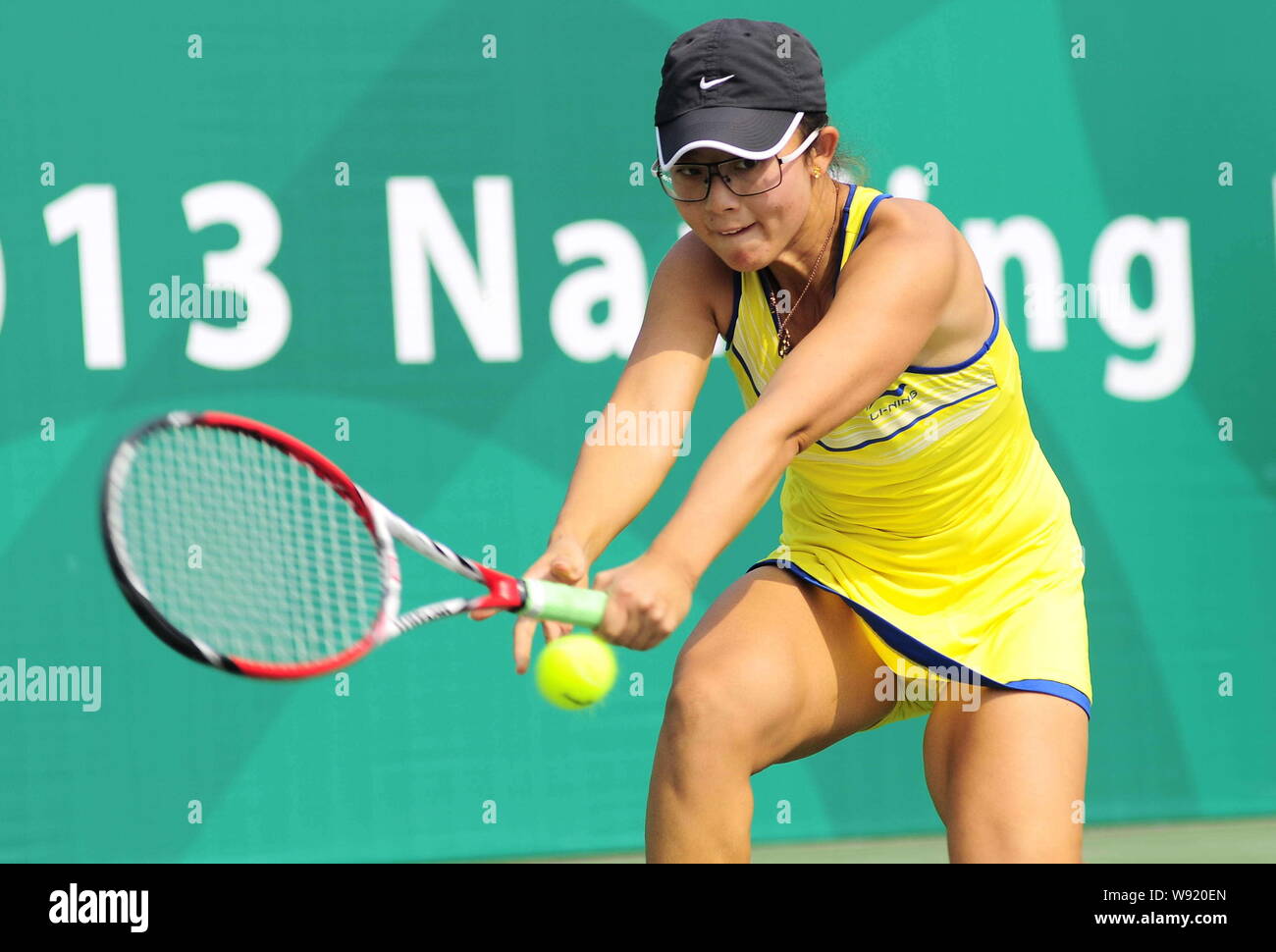 Xu Yifan of China returns a shot to Misaki Doi of Japan in their match during the 2013 Nanjing ...