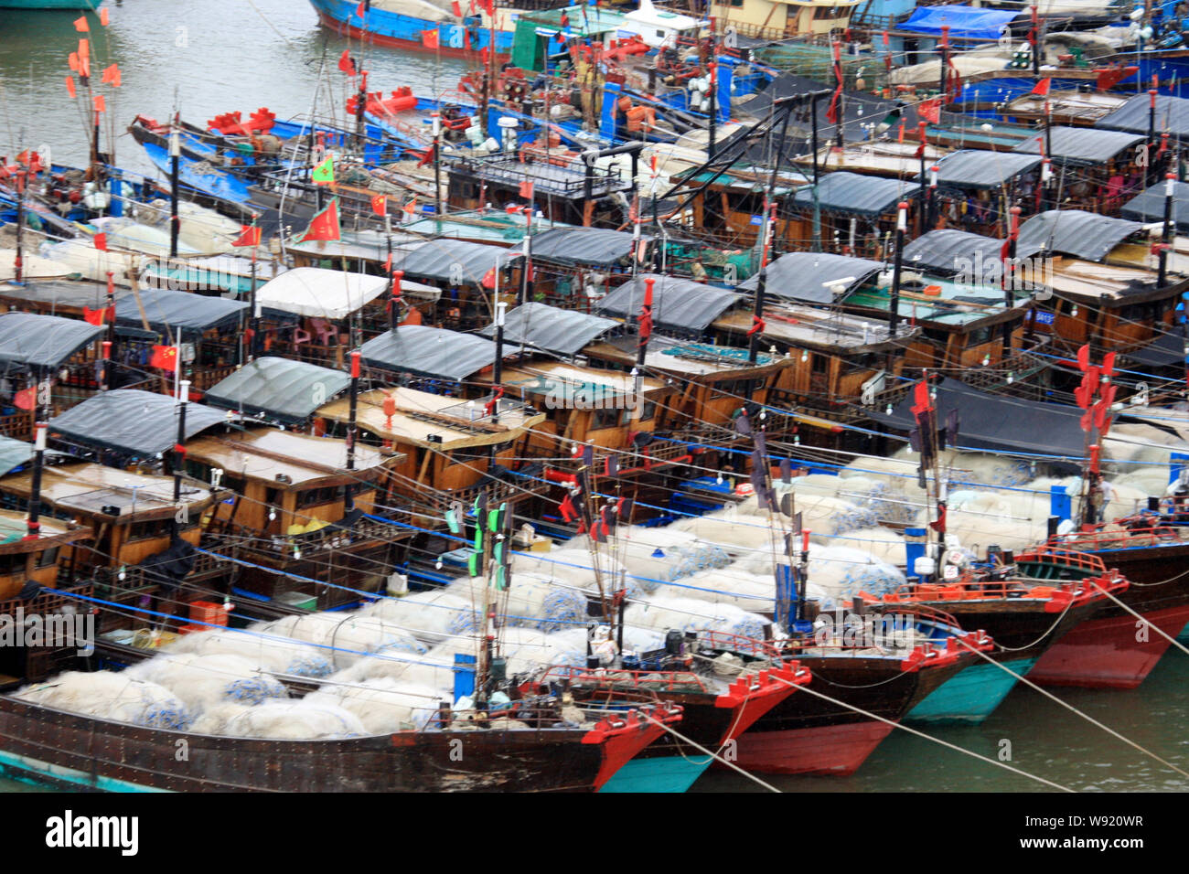 Fishing boats are docked at a harbor as Typhoon Nari approaches in ...