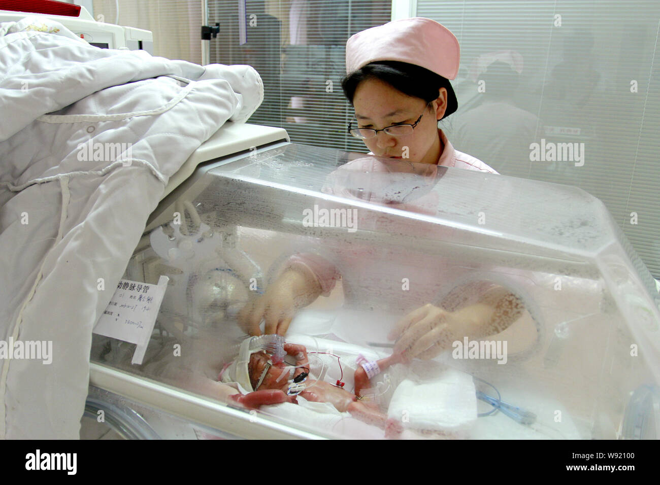 A nurse takes care of the premature female infant receiving medical ...