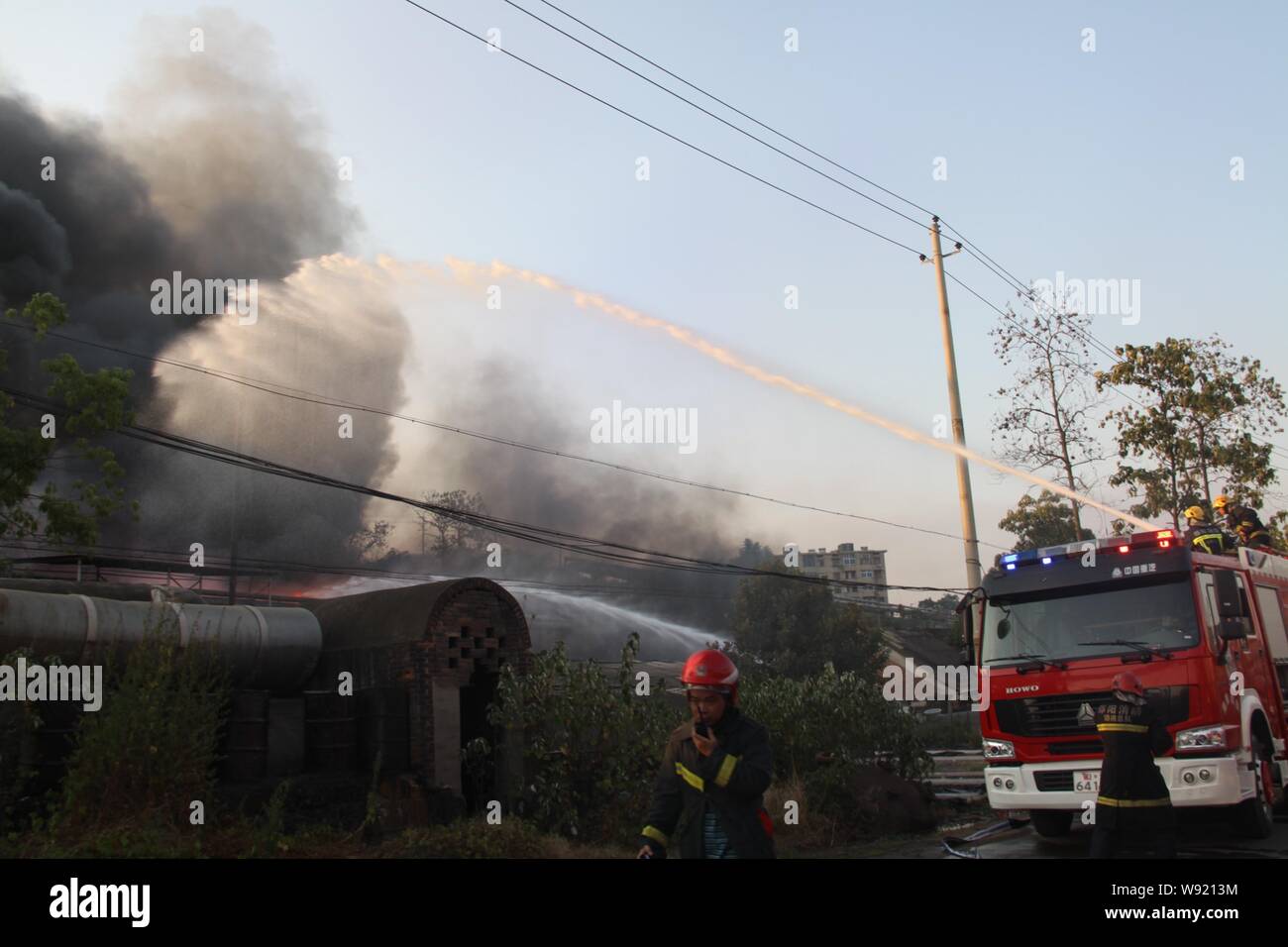 Local Chinese firefighters hose water to put out the fire in a chemical ...