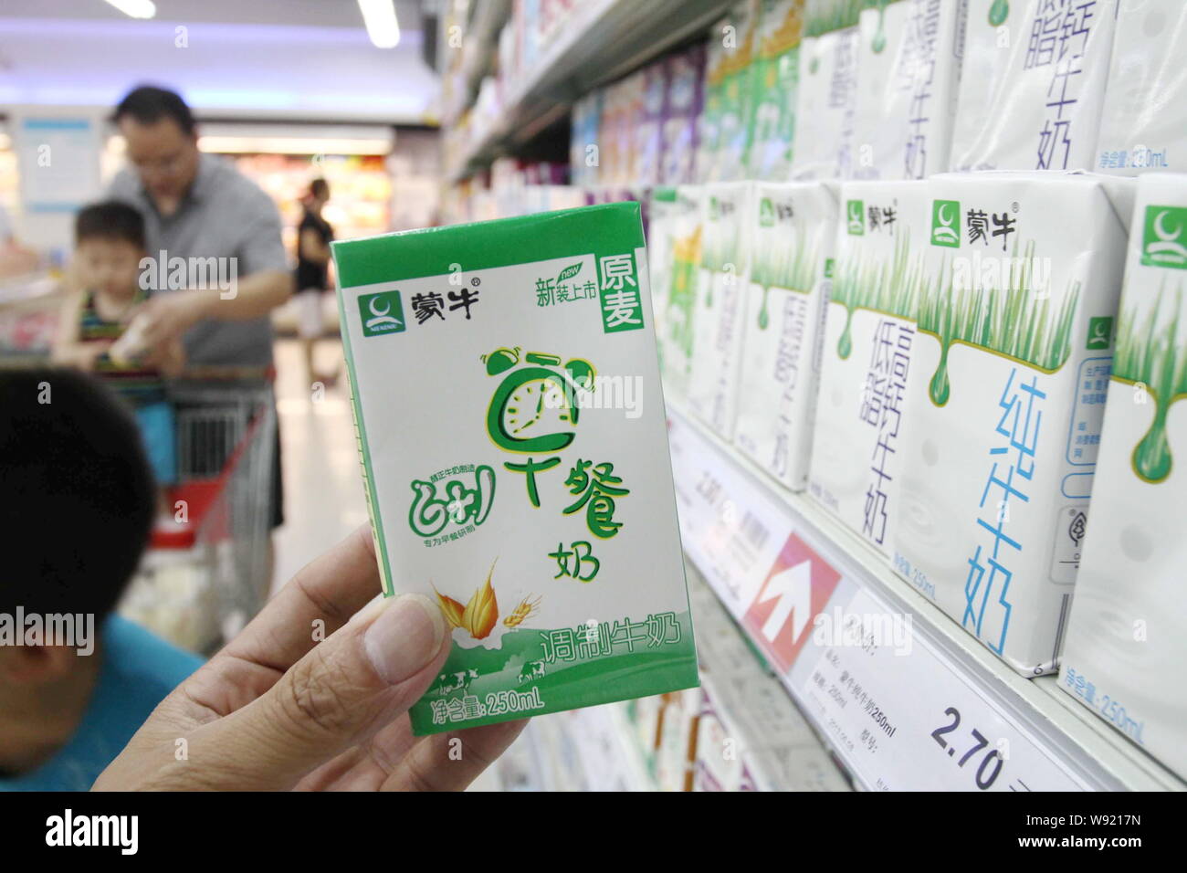 --FILE--A customer buys a box of Mengniu milk at a supermarket in ...