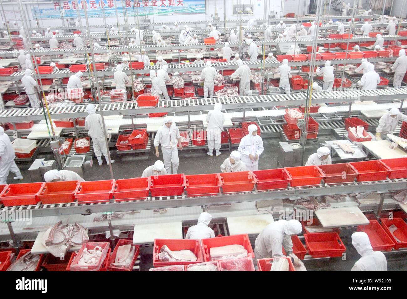 --FILE--Chinese workers cut up pork at the meat processing plant of ...