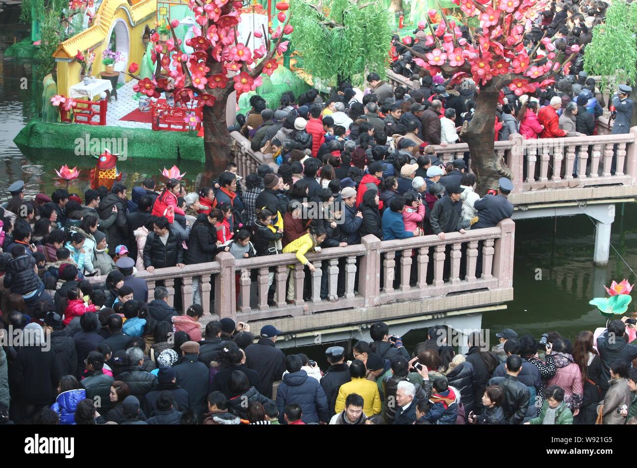 Tourists crowd Jiuqu Bridge at Yu Garden, or Yuyuan Garden, during the ...