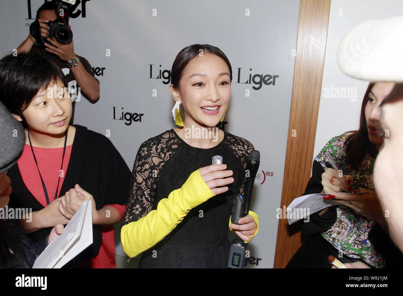 Chinese actress Zhou Xun, center, is interviewed as she arrives for the ...